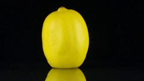 Rotating lemon and its reflection on a b... | Stock Video | Pond5