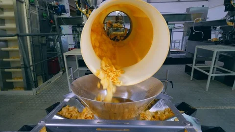 Rotating tube moves potato crisps into a... | Stock Video | Pond5