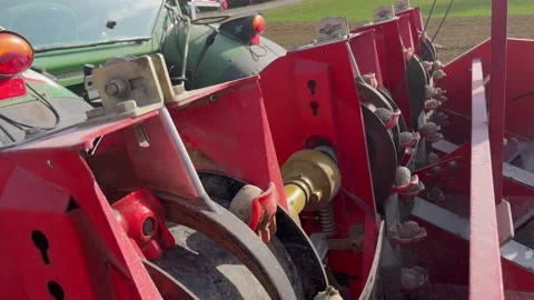 Rotating wheels planting potatoes on a f... | Stock Video | Pond5