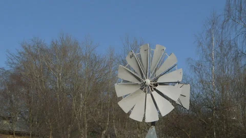 Rotating windmill against the blue sky. | Stock Video | Pond5