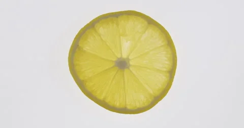 Rotation of a thin transparent lemon sli... | Stock Video | Pond5