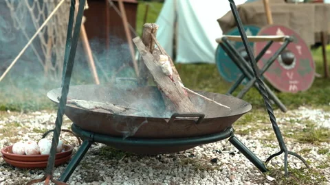 Round cauldron in ancient Roman campfire... | Stock Video | Pond5