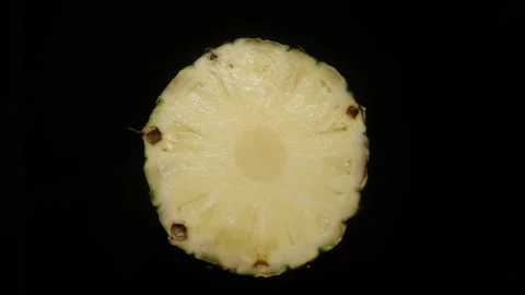 A round slice of chopped pineapple, rota... | Stock Video | Pond5