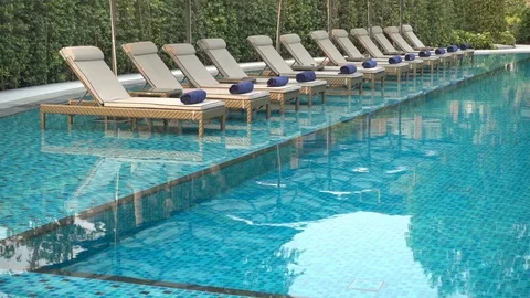 Row of lounge chairs sitting in a resort... | Stock Video | Pond5