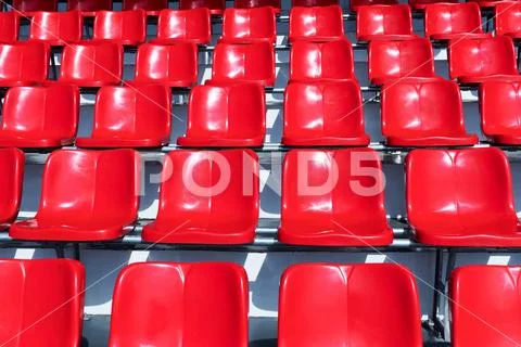 Row of red chair in football sport stadium background ~ Hi Res #114946693