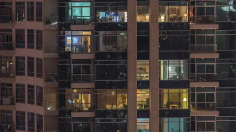 Rows of glowing windows with people in a... | Stock Video | Pond5