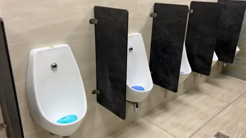 Rows of modern urinals with a sensor WC ... | Stock Video | Pond5