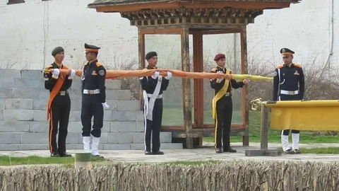 Royal guards roll Bhutanese flag during ... | Stock Video | Pond5