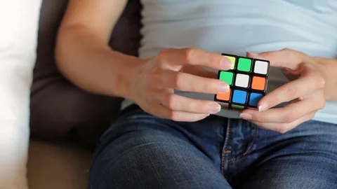 Rubik's cube. Beautiful woman plays with... | Stock Video | Pond5