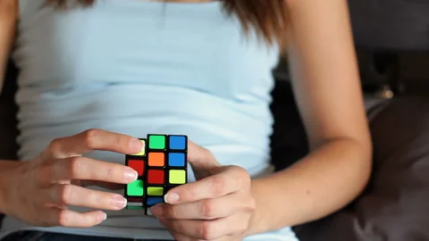 Rubik's cube. Beautiful woman plays with... | Stock Video | Pond5