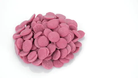 Ruby chocolate chips on white background... | Stock Video | Pond5