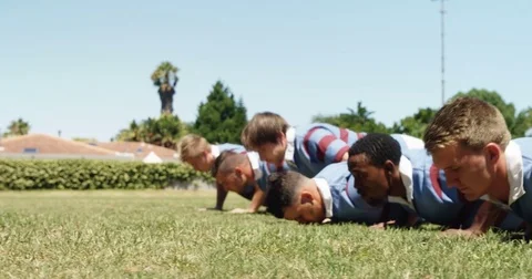 Rugby players doing push ups in the fiel... | Stock Video | Pond5