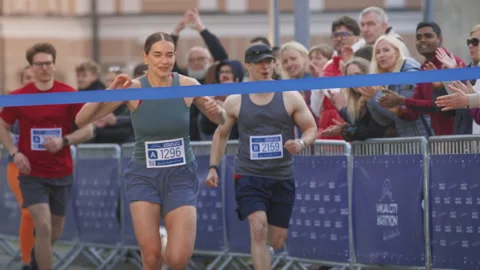 Runner Crossing Finish Line in Marathon | Stock Video | Pond5