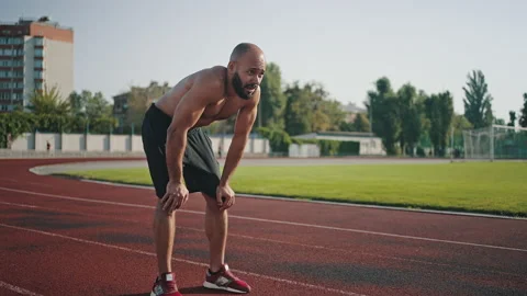 Runner stops for resting on running trac... | Stock Video | Pond5