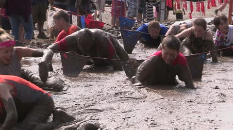 Runners running and crawling through mud... | Stock Video | Pond5