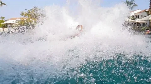 Running into pool from water slide in sl... | Stock Video | Pond5