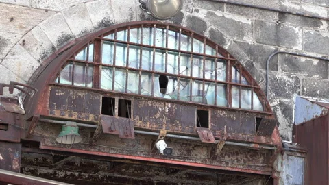 Rusted arched window with cracked glass. | Stock Video | Pond5