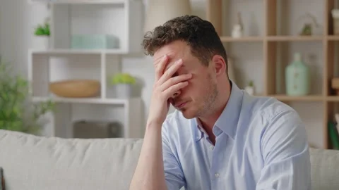 Sad bored man lean head on hand thinking... | Stock Video | Pond5