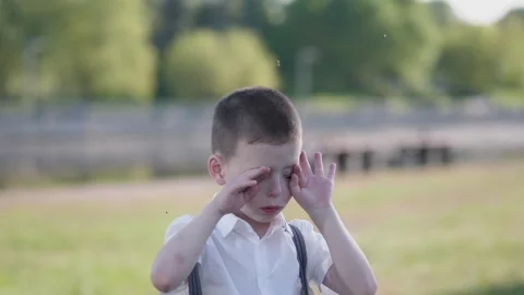 sad boy crying in the park in summer | Stock Video | Pond5