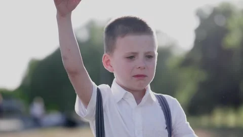 sad boy crying in the park in summer | Stock Video | Pond5