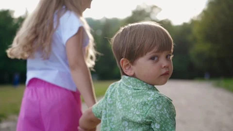 Sad boy going home with a little girl ou... | Stock Video | Pond5