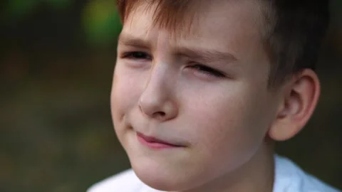 sad calm boy sits alone in the park. clo... | Stock Video | Pond5