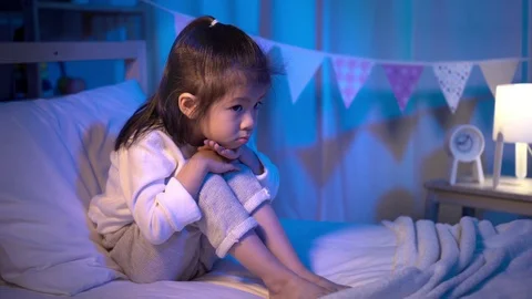 Sad child girl hug her knee and crying o... | Stock Video | Pond5