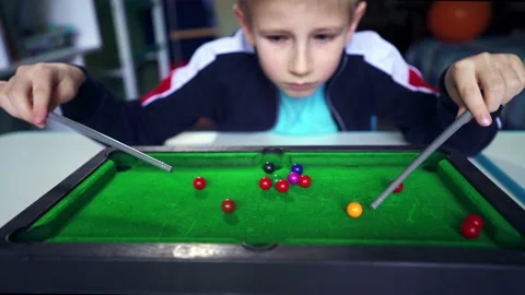 Sad child plays billiards with himself. ... | Stock Video | Pond5