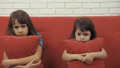 Sad children hugging pillows. Two sister... | Stock Video | Pond5