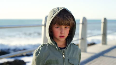 Sad, cold and face of a child at the bea... | Stock Video | Pond5