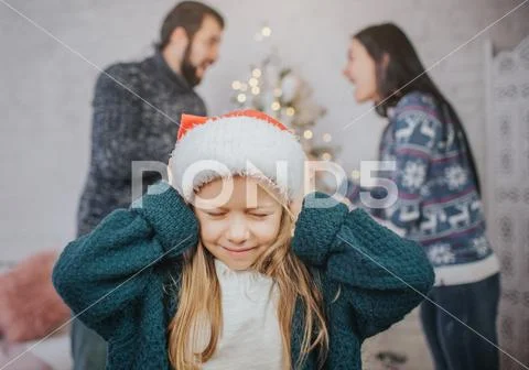 Sad, desperate little girl during parents quarrel. Clog the ears.. Family ~ Hi Res #99194783