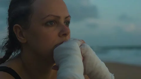 Sad female boxer MMA fighter on beach lo... | Stock Video | Pond5