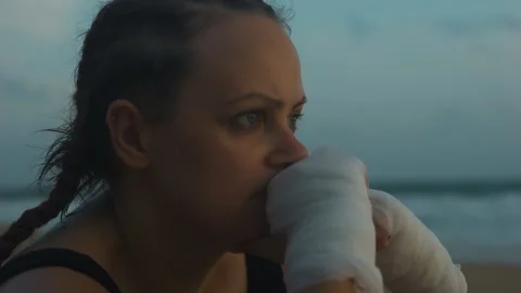 Sad female boxer MMA fighter on beach lo... | Stock Video | Pond5