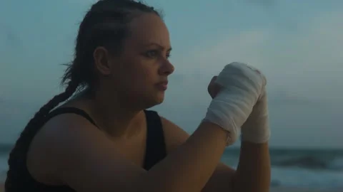 Sad female boxer MMA fighter on beach lo... | Stock Video | Pond5