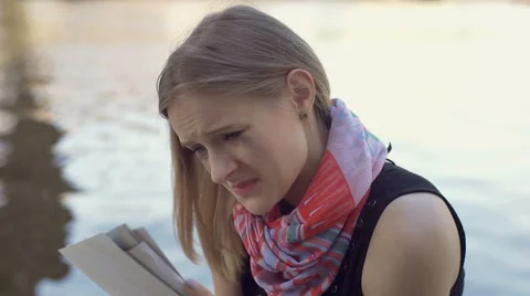Sad girl crying while reading love lette... | Stock Video | Pond5