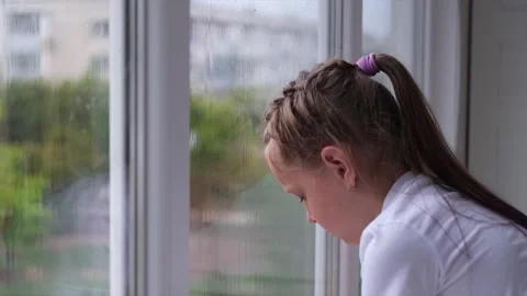 Sad Girl Looking Out Rainy Window