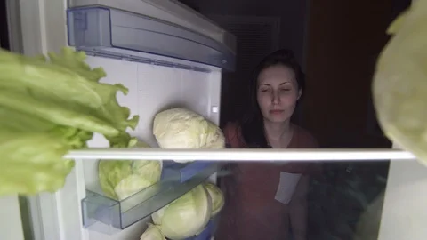 sad girl opens the refrigerator at night... | Stock Video | Pond5