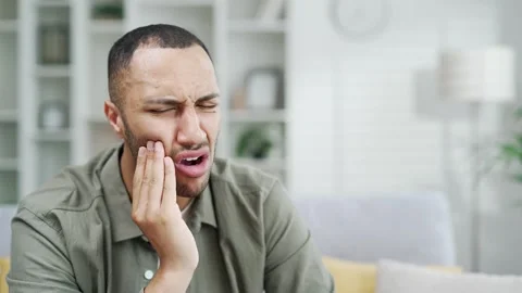 Sad handsome male suffering from toothac... | Stock Video | Pond5