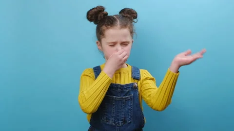 Sad little girl kid smelling something s... | Stock Video | Pond5