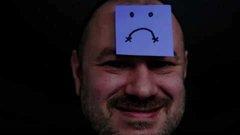 Sad man trying to smile with a sad smile... | Stock Video | Pond5