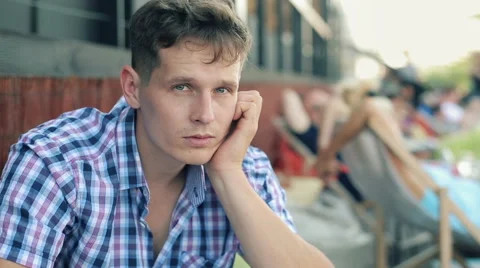 Sad, pensive man sitting in crowded outd... | Stock Video | Pond5