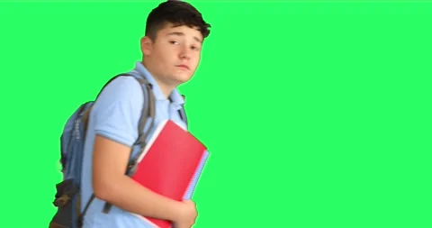 Sad schoolboy at green screen background | Stock Video | Pond5