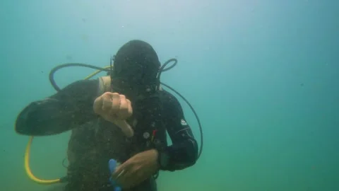 Sad Scuba Diver Shows the Single Use Tra... | Stock Video | Pond5