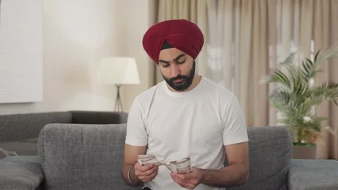 Sad Sikh Indian man counting money | Stock Video | Pond5