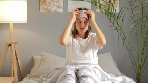 Sad sleepy young woman waking up in unco... | Stock Video | Pond5