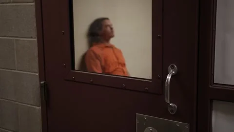 Sad, solemn man, inmate, prisoner, sits ... | Stock Video | Pond5