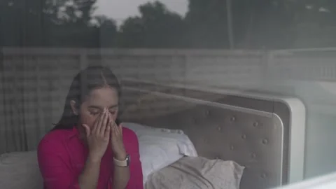 Sad teenage girl crying in bedroom | Stock Video | Pond5