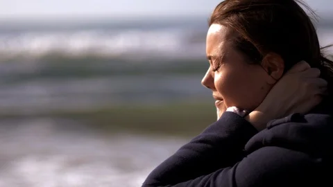 Sad woman crying in front of the ocean i... | Stock Video | Pond5