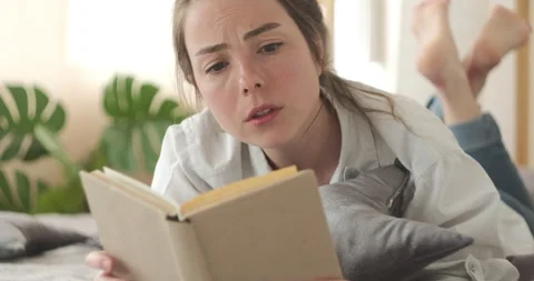 Sad woman crying while reading a book at... | Stock Video | Pond5