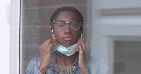 Sad woman with face mask crying behind w... | Stock Video | Pond5